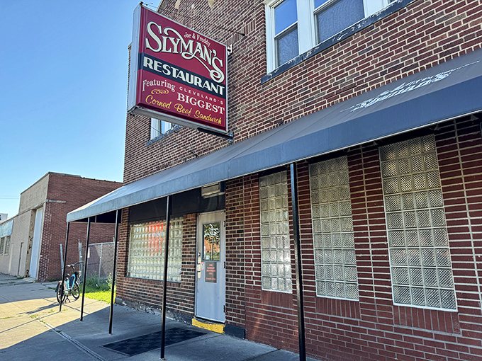 The iconic red Slyman's sign promises Cleveland's BIGGEST corned beef sandwiches&mdash;a bold claim that somehow still manages to be an understatement.