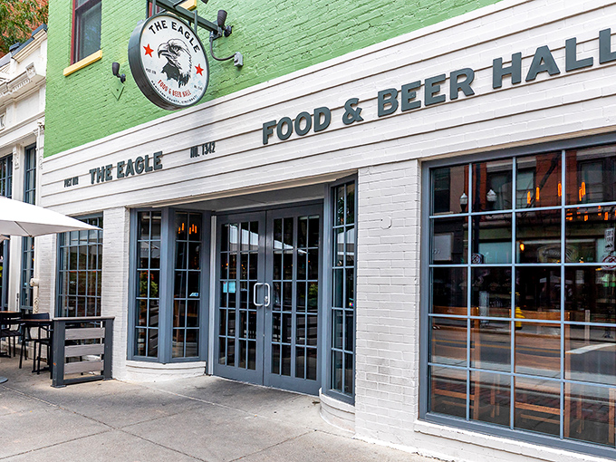 The mint-green facade of The Eagle OTR stands out like a culinary beacon on Vine Street, promising comfort food treasures within its historic walls.