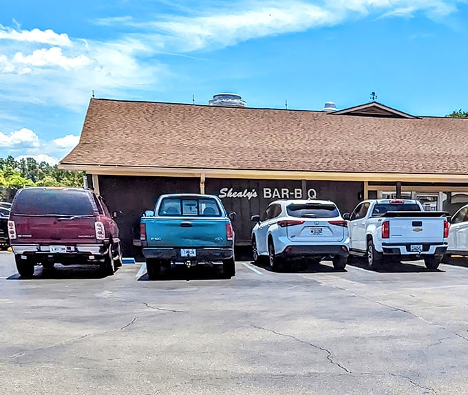 The unassuming exterior of Shealy's Bar-B-Q belies the culinary treasures within, as evidenced by the perpetually full parking lot.