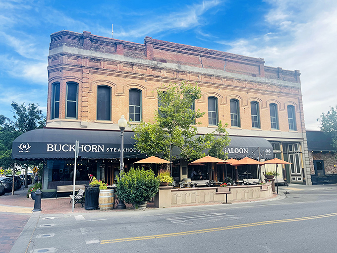 Historic charm meets carnivore's paradise at Buckhorn Steakhouse's brick exterior, where those awnings might as well read "Abandon your diet, all ye who enter here."