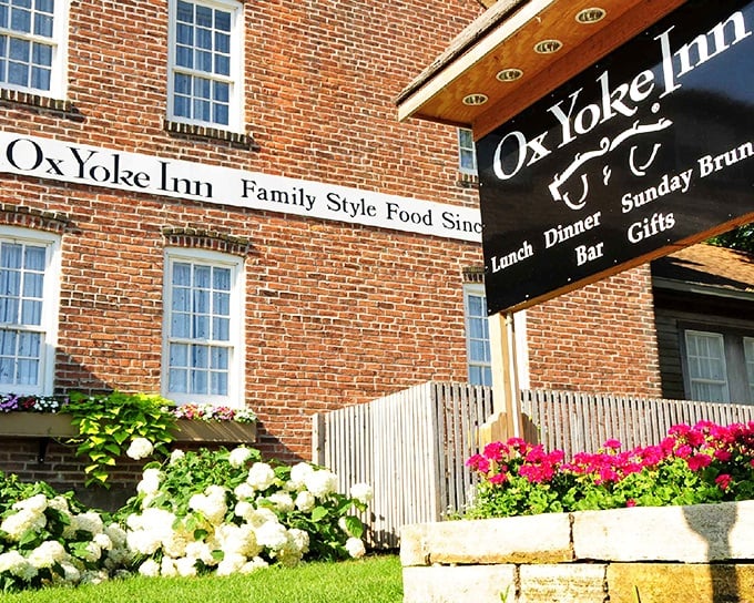 The iconic brick exterior of Ox Yoke Inn welcomes hungry travelers with colorful flower beds and a promise of German-American comfort that's stood the test of time.