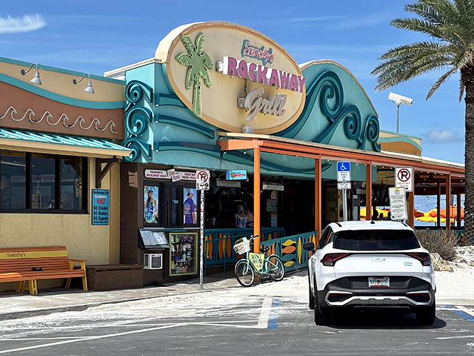The iconic wave-inspired facade of Frenchy's Rockaway Grill welcomes beach-goers with its vibrant colors and promise of seafood paradise.