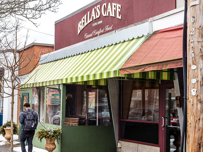 A snowy day outside can't dim the charm of Bella's Cafe, where the green and white striped awning stands out like a culinary beacon in Westville.