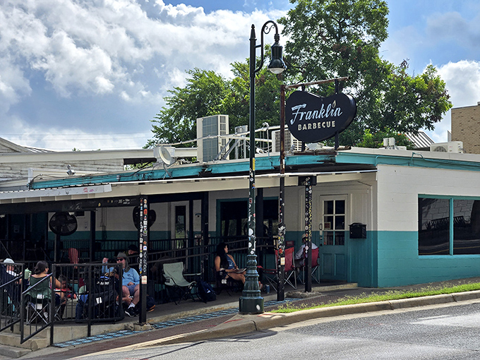 The pilgrimage begins here: Franklin Barbecue's iconic turquoise-trimmed exterior, where the line forms before dawn and dreams of perfect brisket are born.