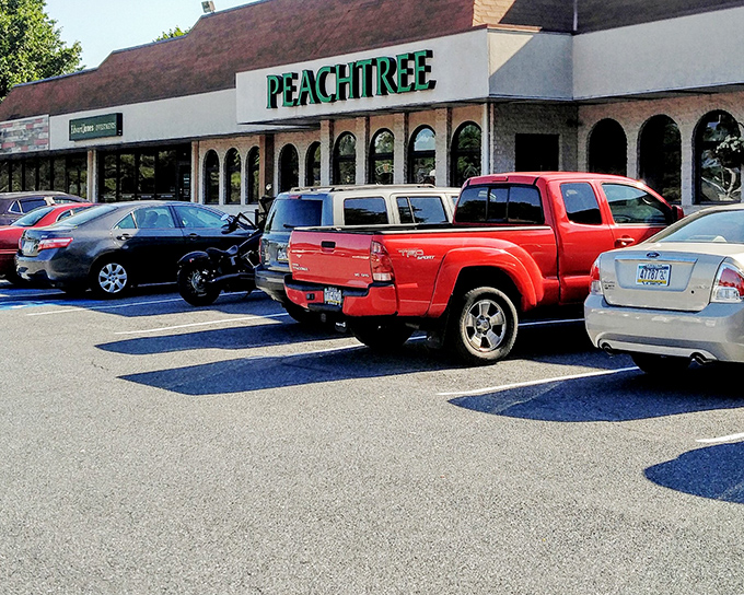 The iconic green Peachtree sign welcomes hungry patrons like a beacon of breakfast hope. Those arched windows hint at the culinary treasures waiting inside.