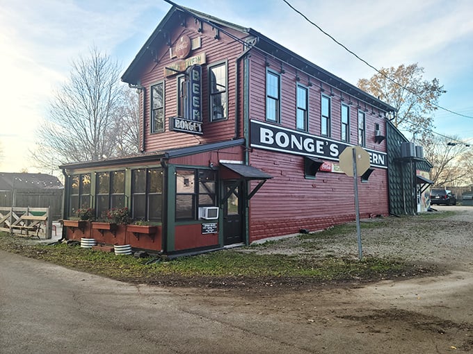 The unassuming red exterior of Bonge's Tavern stands like a culinary mirage in rural Indiana, where legendary steaks and unforgettable dining experiences await the patient and the hungry.