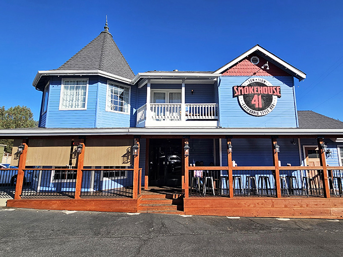 The bright blue exterior of Smokehouse 41 BBQ stands out like a beacon for hungry travelers, promising smoky delights within those welcoming walls.
