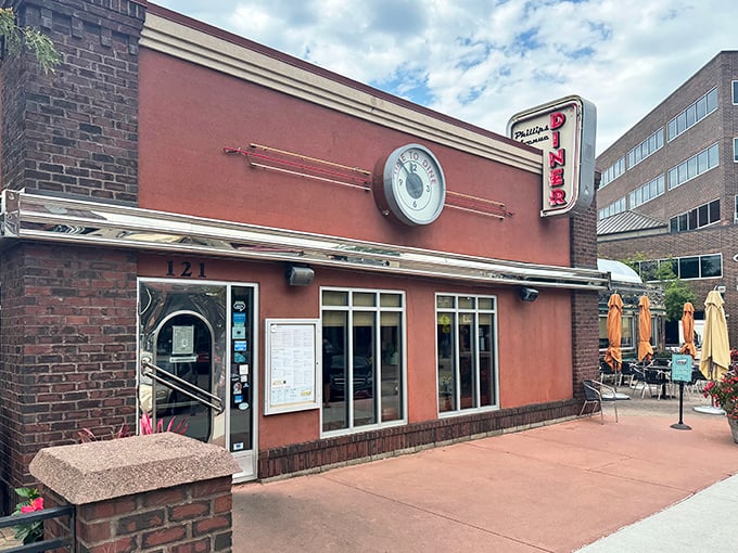 The red facade and vintage clock of Phillips Avenue Diner stands as downtown Sioux Falls' time machine to comfort food paradise.