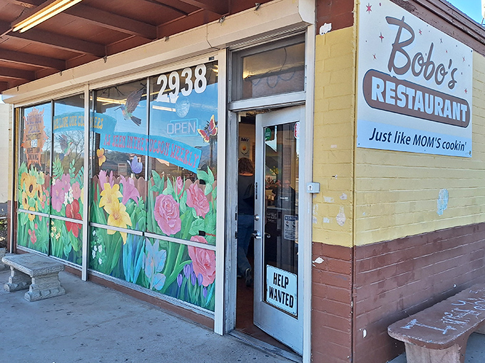 The cheerful yellow exterior of Bobo's, with its hand-painted flower murals, feels like stumbling upon a secret garden that happens to serve incredible breakfast.