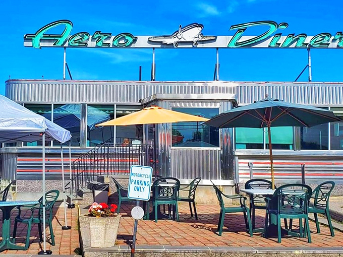 The gleaming silver exterior of Aero Diner catches Connecticut sunlight like a time machine from the 1950s, complete with outdoor seating for those perfect New England summer mornings.