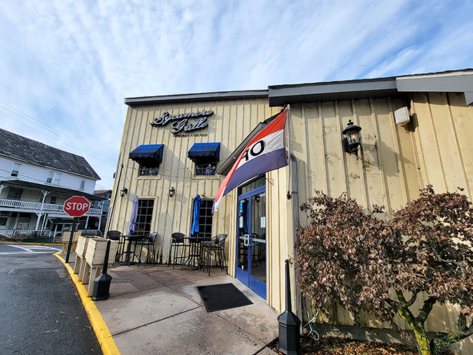 The beige exterior with blue awnings beckons like an old friend. Outdoor seating perfect for people-watching while savoring that first bite of heaven.