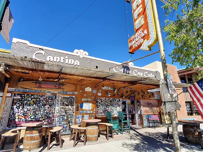 The iconic facade of The Coffee Cup Cafe beckons with its vibrant signage and sticker-covered walls &ndash; Boulder City's breakfast paradise in all its glory.