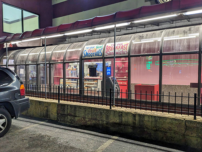 The unassuming storefront beckons like a pink neon lighthouse in the night, promising sweet salvation for donut-deprived souls.