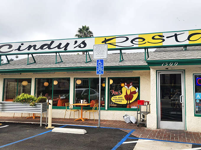 The sunshine-yellow facade of Cindy's Diner promises retro comfort before you even step inside. California palm trees and classic signage complete the time-travel experience.