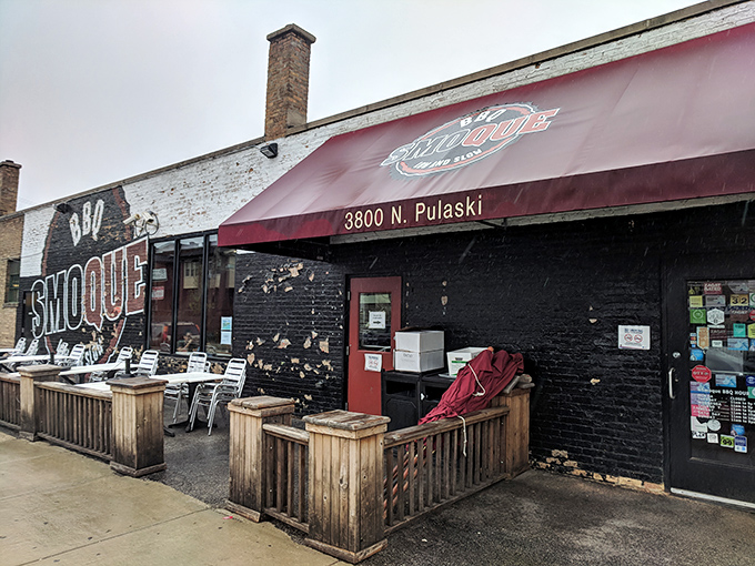 The iconic black and burgundy exterior of Smoque BBQ stands like a temple to smoked meat on Chicago's Pulaski Road, beckoning hungry pilgrims with its no-nonsense charm.