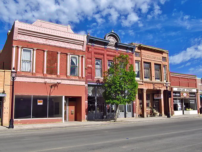 Historic charm meets small-town affordability along Aztec's Main Street, where these brick buildings have witnessed generations of community life unfolding beneath New Mexico's impossibly blue skies.