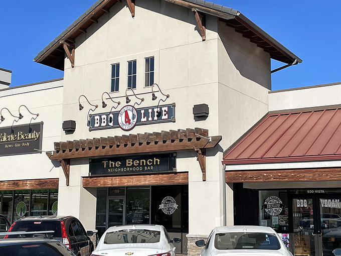 The rust-red roof and welcoming storefront signal that something special awaits inside this Boise barbecue haven.
