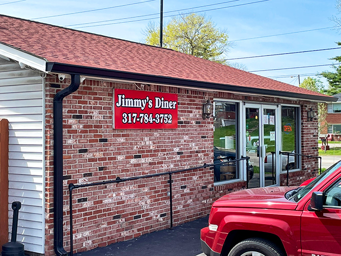 The brick exterior whispers "come in" while the red sign practically shouts it with Midwestern friendliness.