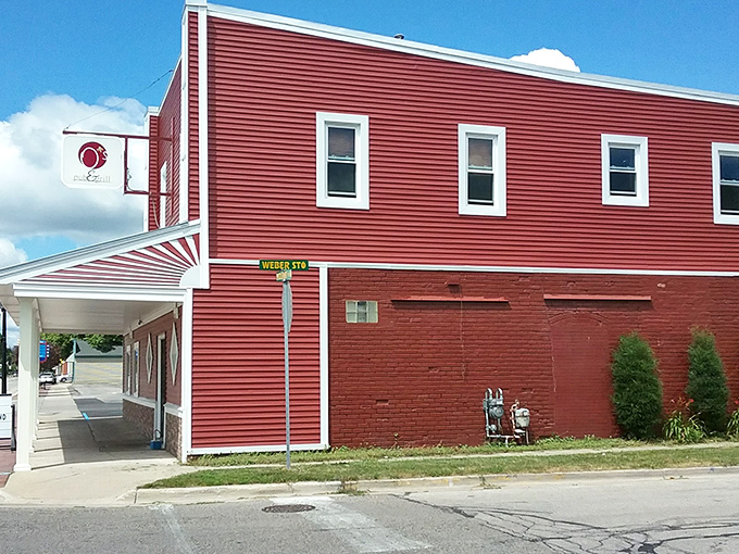 A classic Michigan pub facade with stone accents and white trim &ndash; where culinary magic happens behind modest walls.