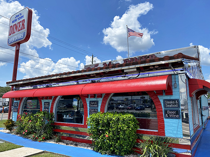 Joe's iconic red exterior and classic diner sign beckon hungry Floridians under Tampa's blue skies, promising 24-hour comfort food paradise.