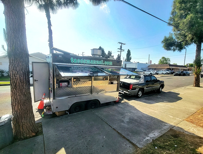 The unassuming silver chariot of culinary dreams, parked beneath palm trees like California's tastiest secret hiding in plain sight.