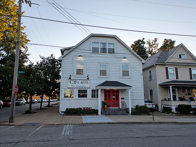 The charming white clapboard exterior of Colao's Ristorante stands like a beacon of culinary promise on an Erie corner, its red door practically winking at hungry passersby.