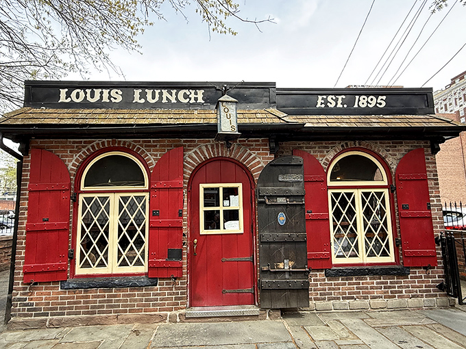 The little brick building with bright red shutters stands like a culinary time capsule in New Haven, proudly defying the march of progress.