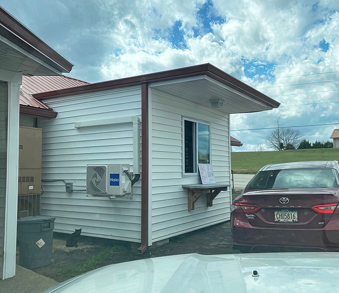 The drive-thru window at Zeb's proves good things come in small packages. No fancy architecture needed when the barbecue speaks volumes through this humble service window.