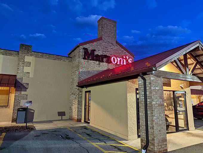 Marzoni's iconic red sign glows against the twilight sky, like a lighthouse guiding hungry travelers to culinary salvation.