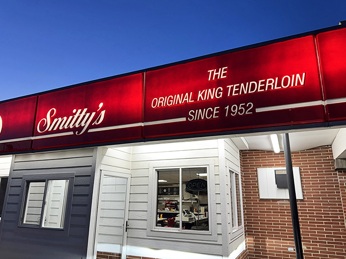 The iconic red awning of Smitty's glows like a beacon of hope for hungry travelers. "Original King Tenderloin" isn't just marketing&mdash;it's a seven-decade promise kept.
