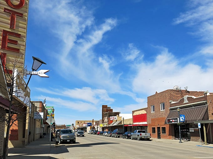 Main Street stretches toward infinity under Montana's impossibly blue sky, where brick buildings stand like sentinels guarding small-town treasures waiting to be discovered.