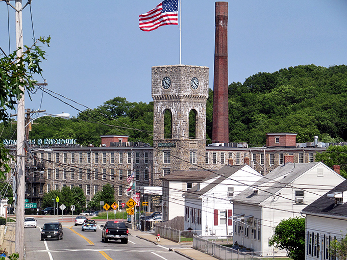 Industrial grandeur meets small-town America. The iconic mill tower stands sentinel over West Warwick, a testament to Rhode Island's manufacturing heritage.
