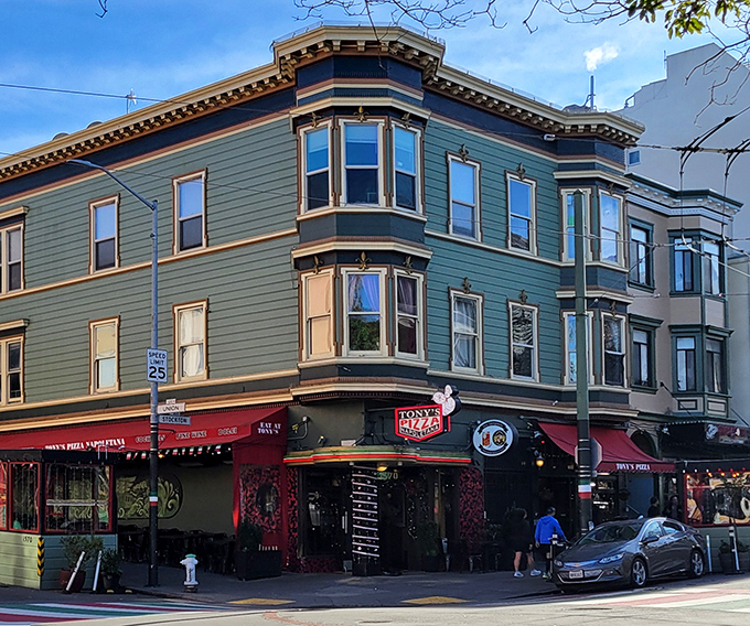The iconic green corner building with its classic San Francisco bay windows stands like a beacon for pizza pilgrims in North Beach.