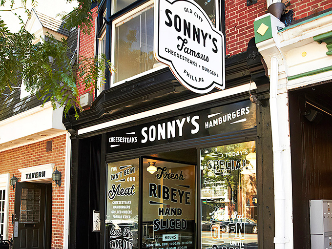 Nestled in Old City's historic brick landscape, Sonny's Famous Steaks beckons with its classic black awning and promise of Philadelphia's twin treasures: cheesesteaks and burgers.