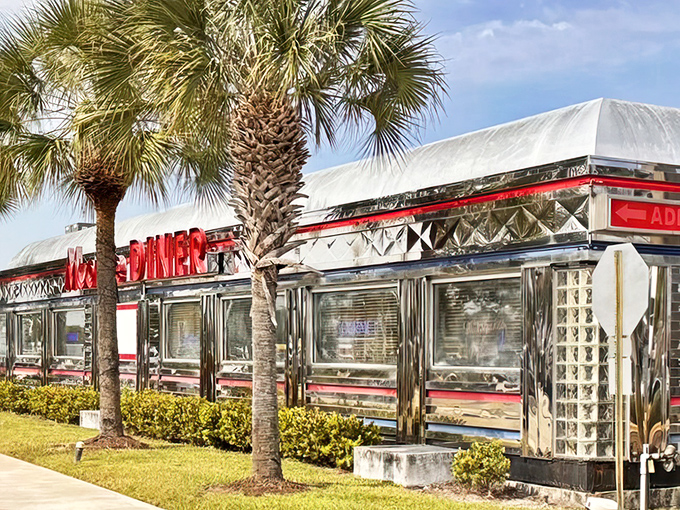 Chrome gleaming in the Florida sunshine, Moonlite Diner's classic exterior promises a time-traveling culinary adventure beneath those swaying palm trees.