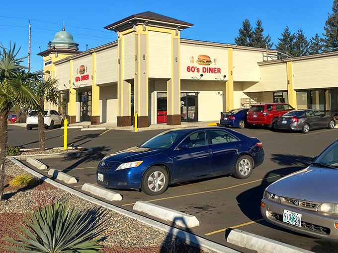 The golden dome and sunny yellow exterior of 60's Caf&eacute; & Diner stands like a beacon of hope for hungry travelers. Classic cars in the lot hint at the time-traveling experience waiting inside.