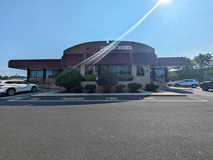 The Club House Diner stands proudly against the Pennsylvania sky, its burgundy awning like a welcoming embrace for hungry travelers and locals alike.