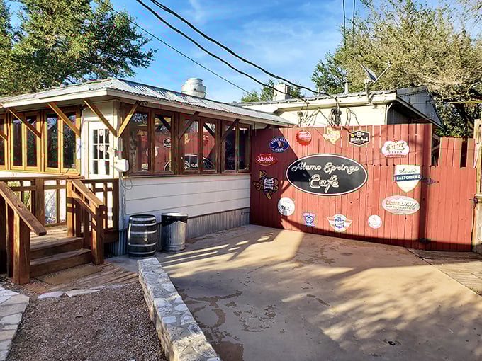 Check out this patio! The colorful wall art and outdoor seating promise a casual, lively spot to enjoy a cold drink and a great burger.