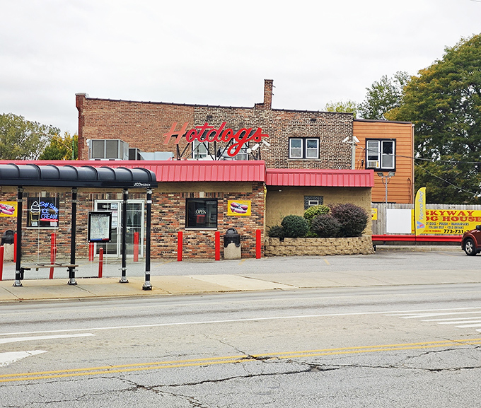 The brick-and-mortar temple of tubular meat worship stands proudly on a Chicago corner, its red awning beckoning hungry pilgrims to hot dog heaven.