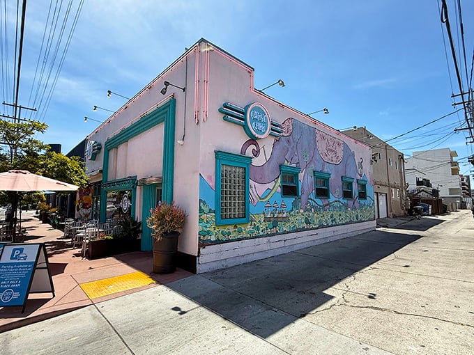 The whimsical pink exterior with its playful elephant mural invites you into Crest Cafe's world of breakfast magic in Hillcrest.