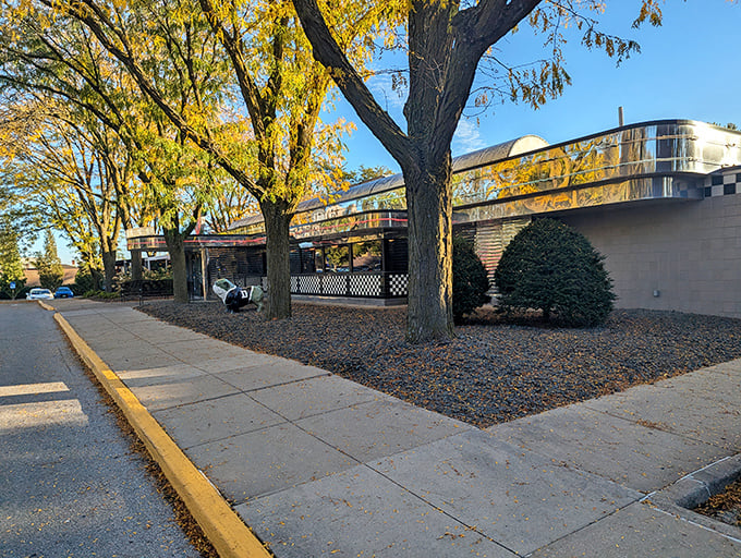 Fall foliage frames this chrome-clad time machine, where Drake Diner's vintage exterior promises a journey back to when calories were just numbers.