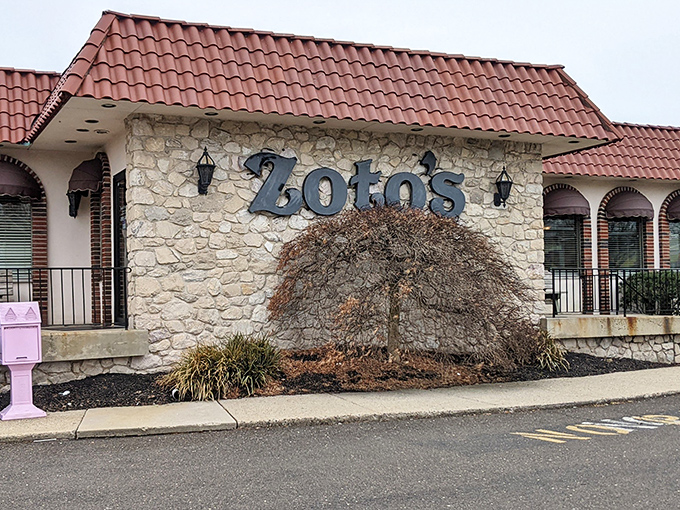 The stone facade and burgundy roof of Zoto's Diner stands like a culinary lighthouse on Bethlehem Pike, beckoning hungry travelers with promises of comfort food perfection.