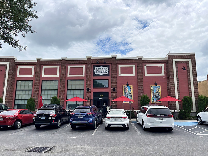 That brick facade with its bold pink panels and vintage signage announces you've arrived somewhere special in Orlando's dining scene.