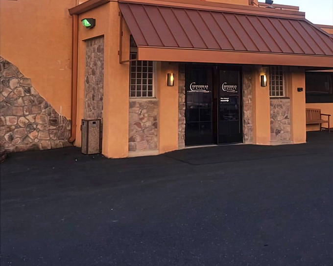 The stone and stucco exterior of Copperhead Grille stands like a culinary fortress, promising comfort and satisfaction behind those unassuming doors.