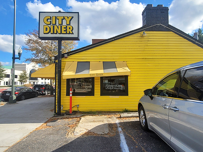 Sunshine yellow with matching awnings, City Diner's cheerful exterior promises comfort food that brightens even the gloomiest Monday.