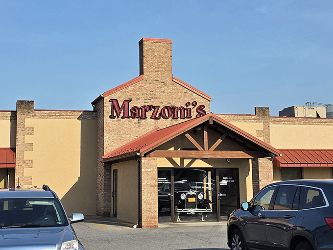 Marzoni's iconic red sign glows against the twilight sky, like a lighthouse guiding hungry travelers to culinary salvation.