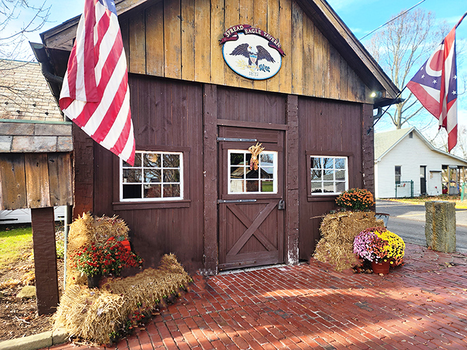 The Spread Eagle Tavern welcomes you with rustic charm, hay bales, and flags that practically salute you into a historic dining adventure.