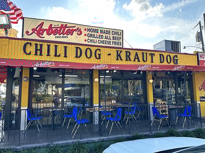 Red awnings and blue chairs create Miami's most patriotic hot dog sanctuary, where locals have been pledging allegiance to chili dogs since 1959.