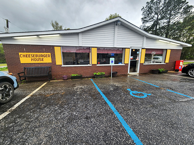 The humble brick exterior of Johnny's Cheeseburger House proves once again that the best culinary treasures often hide in plain sight, complete with welcoming bench and cheerful yellow signage.