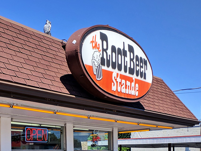 The humble exterior of The Root Beer Stande stands as a time capsule of Americana, where culinary treasures await behind those unassuming service windows.